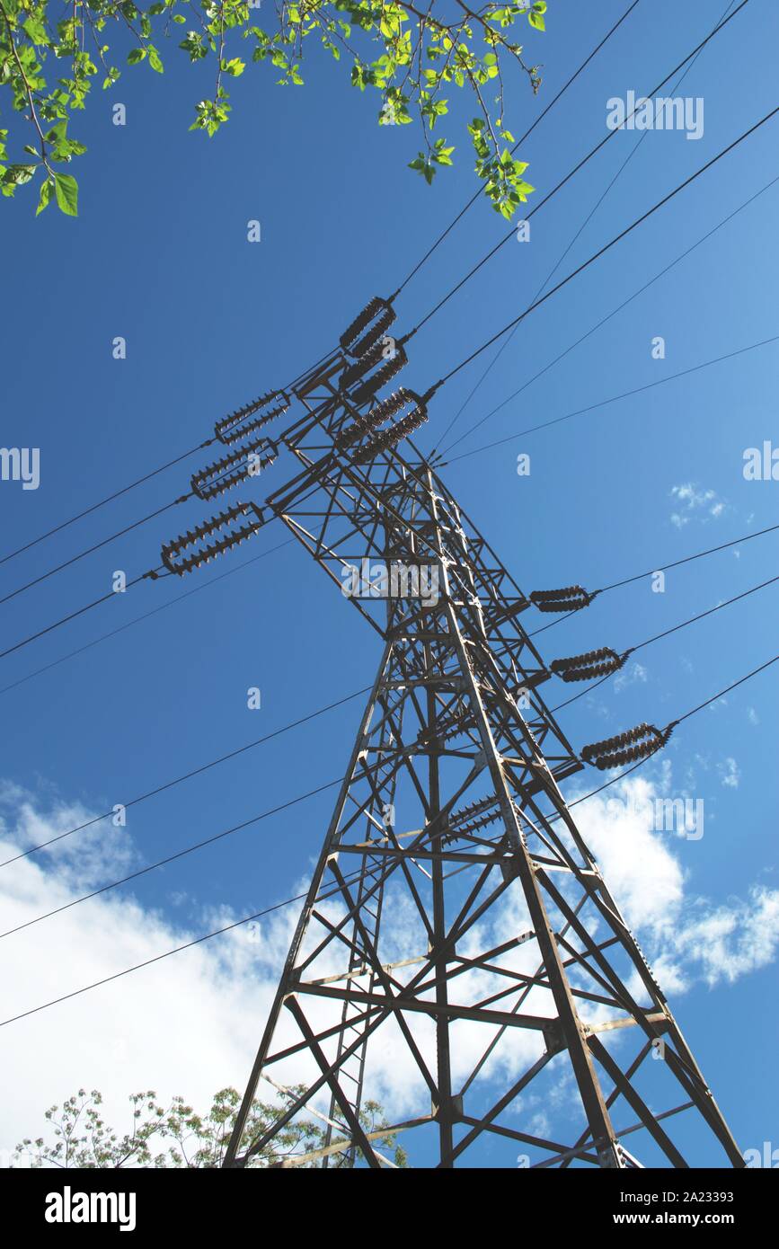 Steel frame electrical pylon. Low angle shot against a blue sky Stock ...