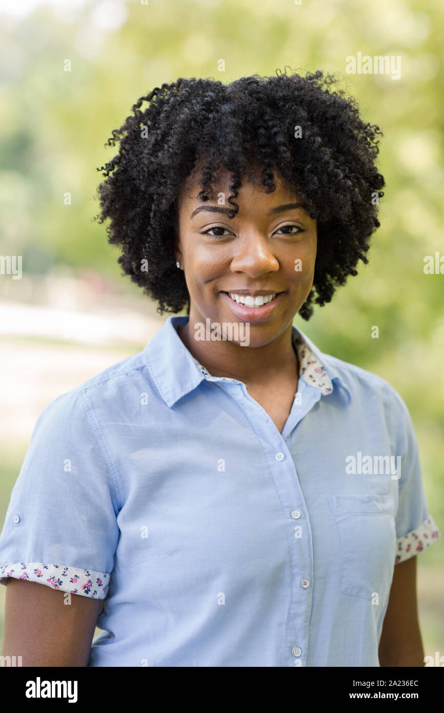 Happy African American woman with curly hair Stock Photo - Alamy