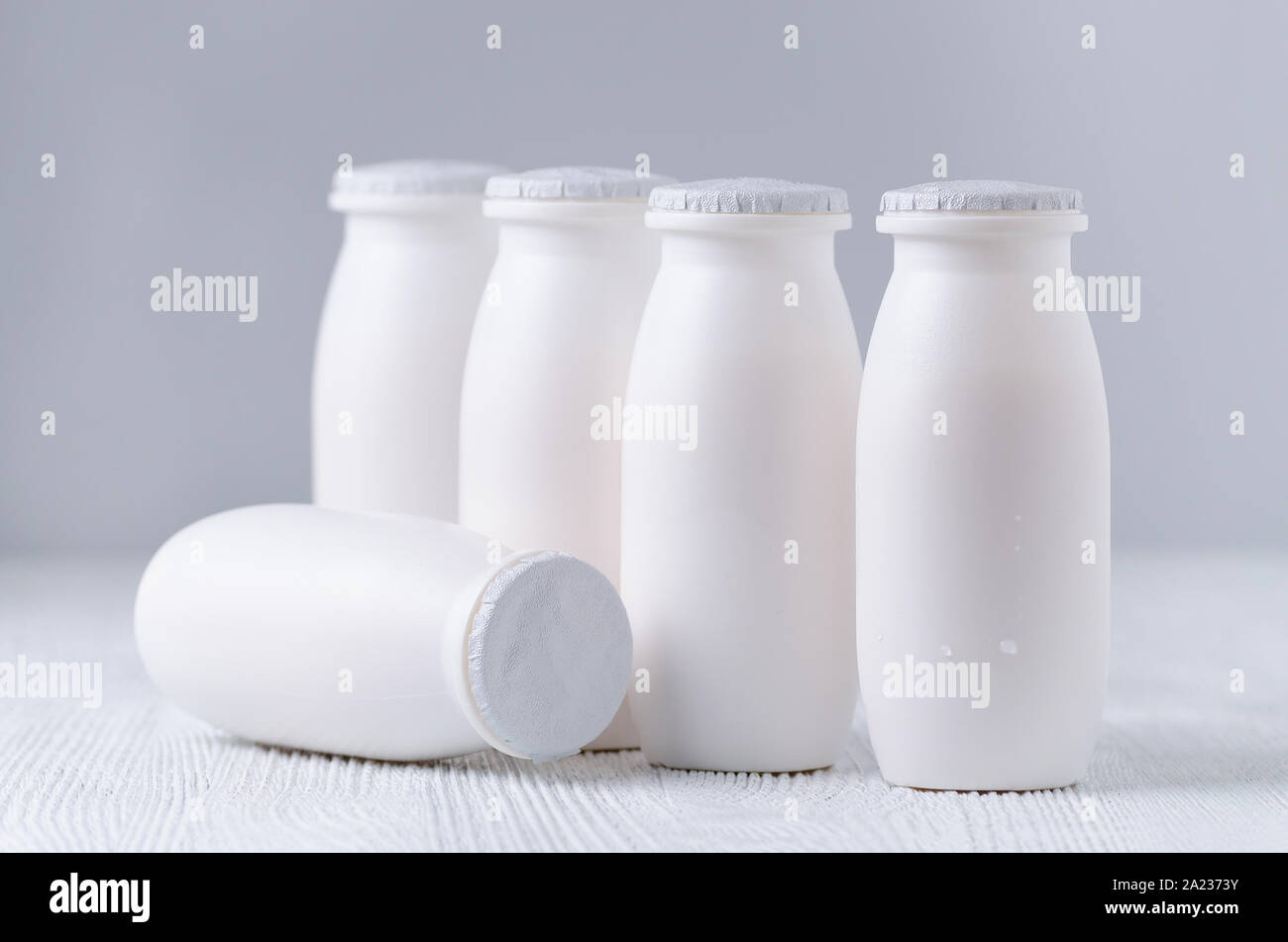 bottles of drink yogurt on gray background Stock Photo - Alamy