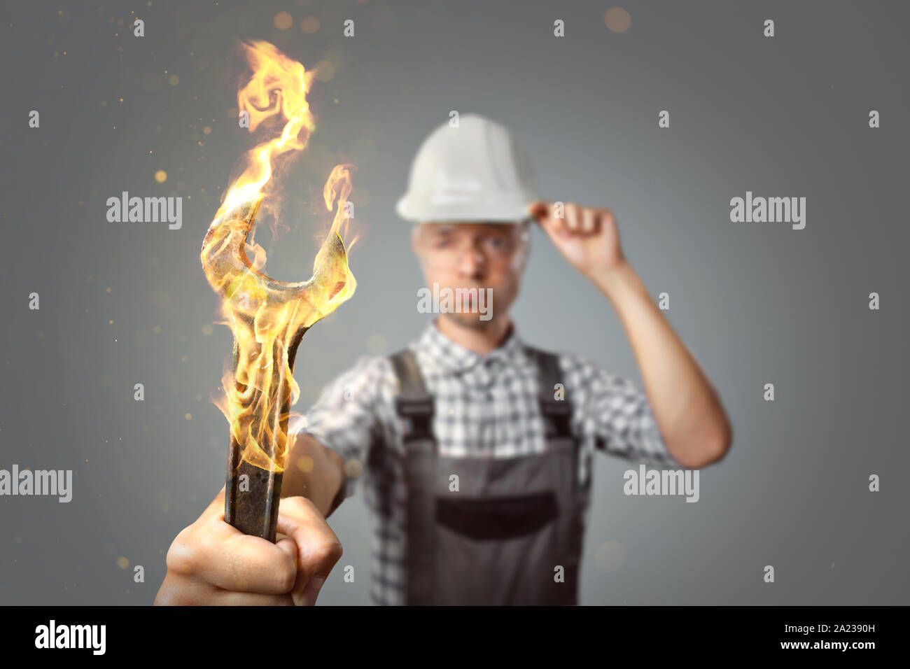 Craftsman holding a burning wrench tool Stock Photo - Alamy