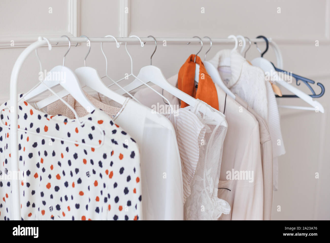 Clothes hang on a shelf in a designer clothes store Stock Photo - Alamy