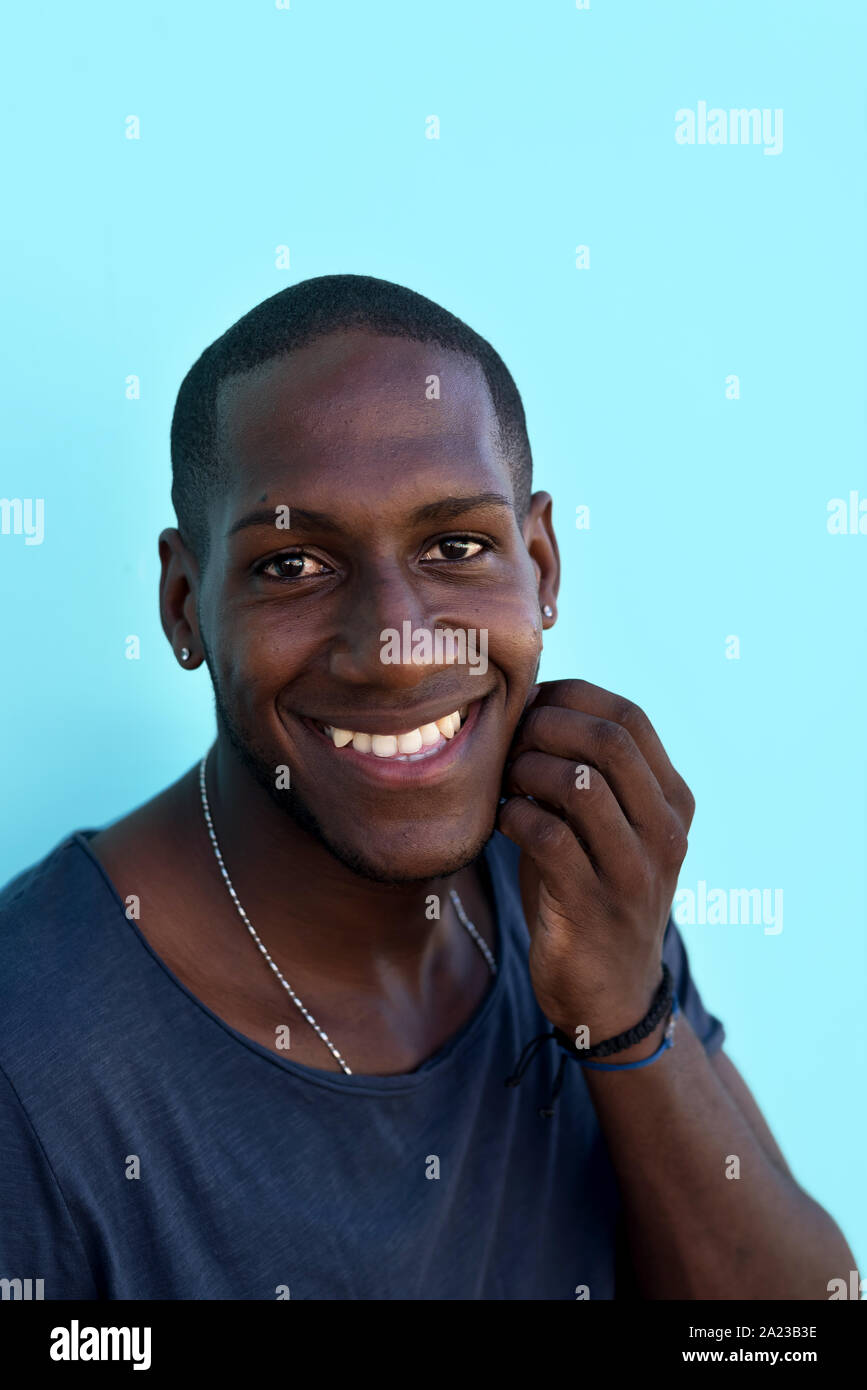 Portrait of an african man in front of a colorful wall Stock Photo - Alamy