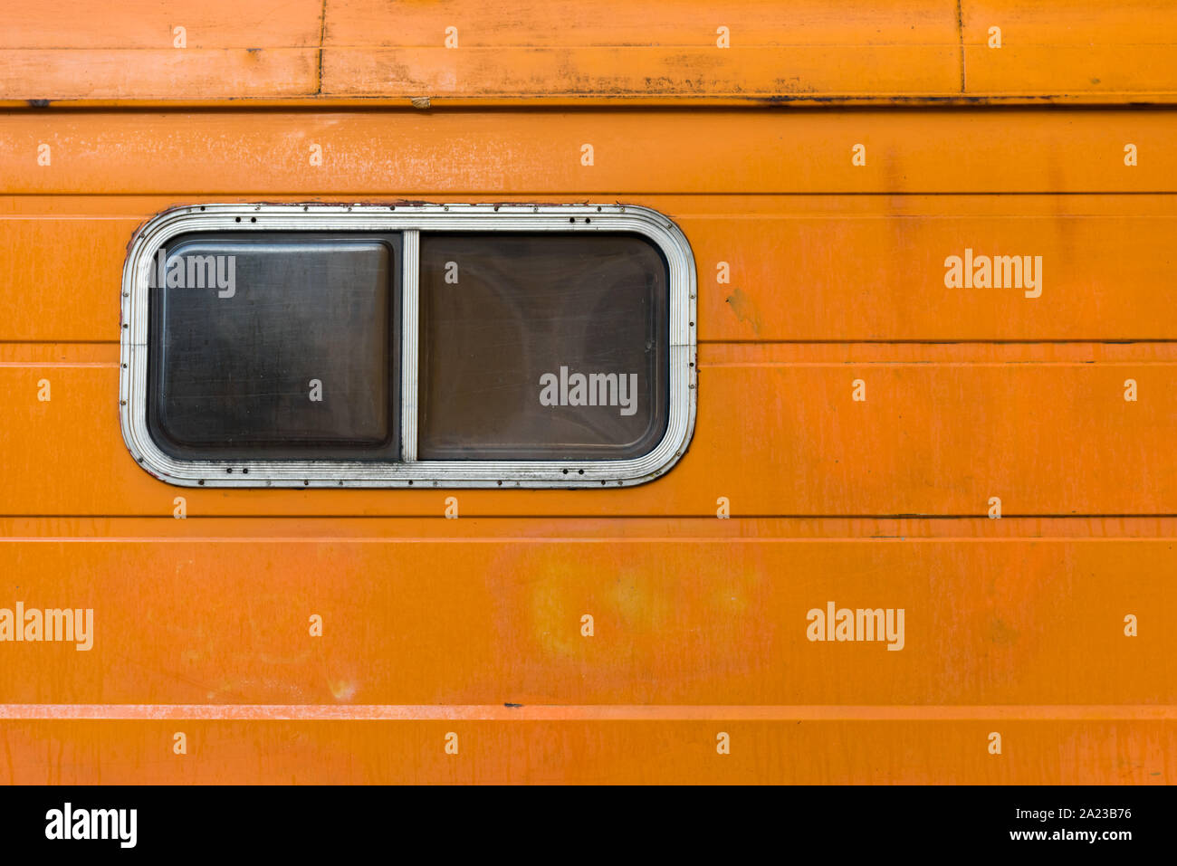 The orange old caravan with the plastic window Stock Photo - Alamy