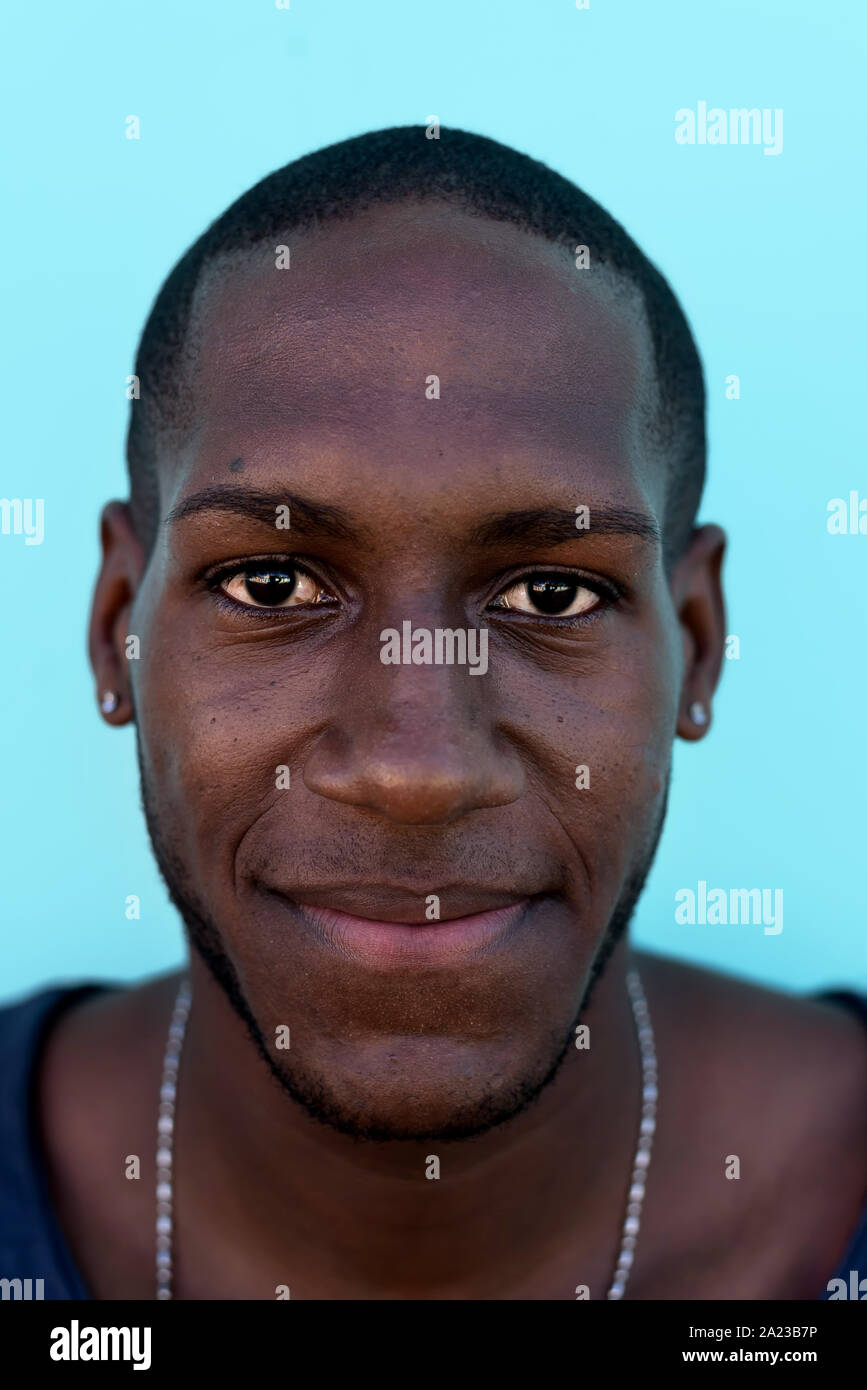 Portrait of an african man in front of a colorful wall Stock Photo - Alamy