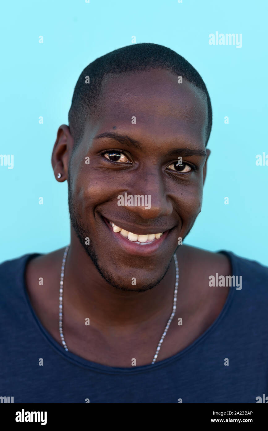 Portrait of an african man in front of a colorful wall Stock Photo - Alamy