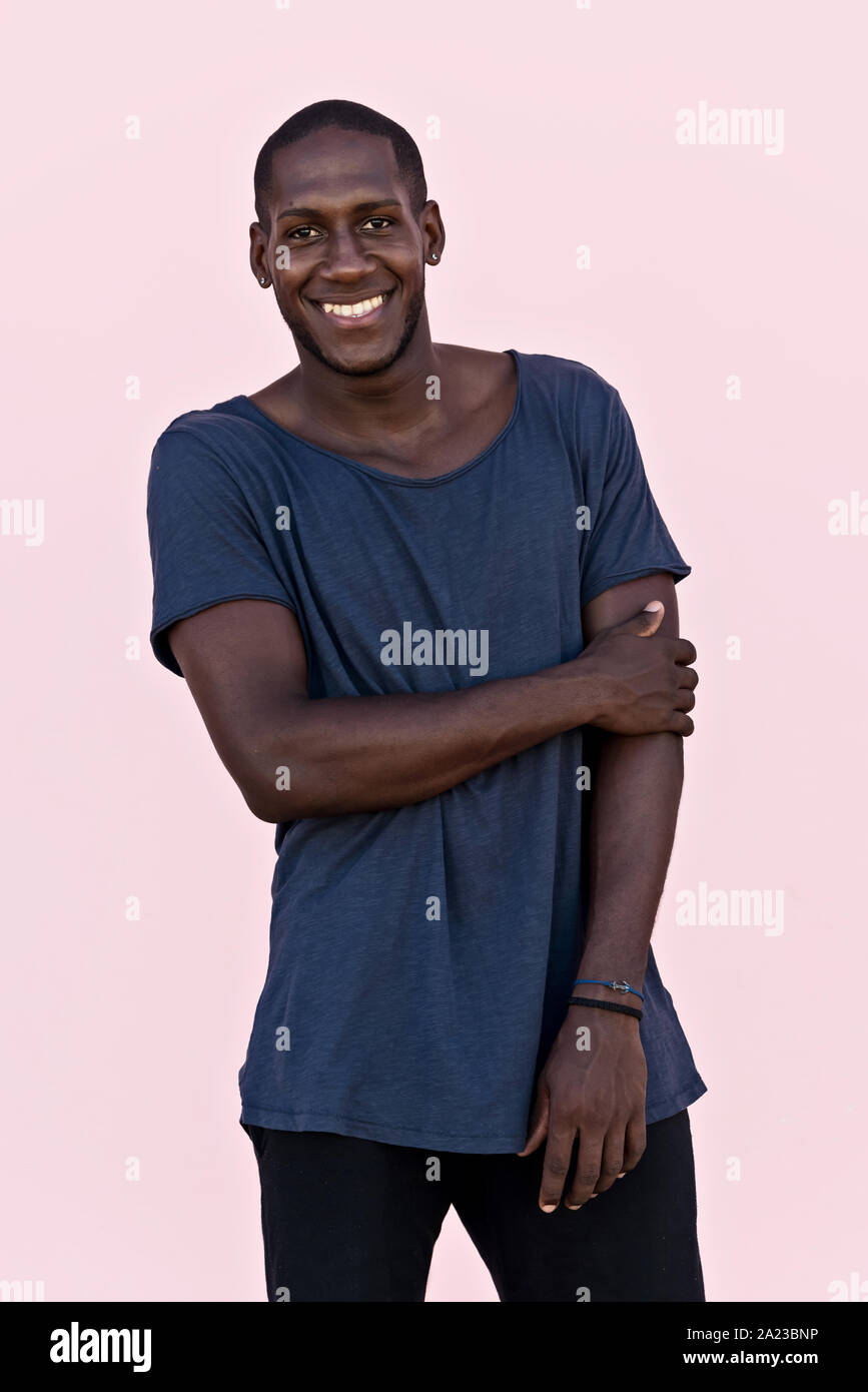 Portrait of an african man in front of a colorful wall Stock Photo - Alamy