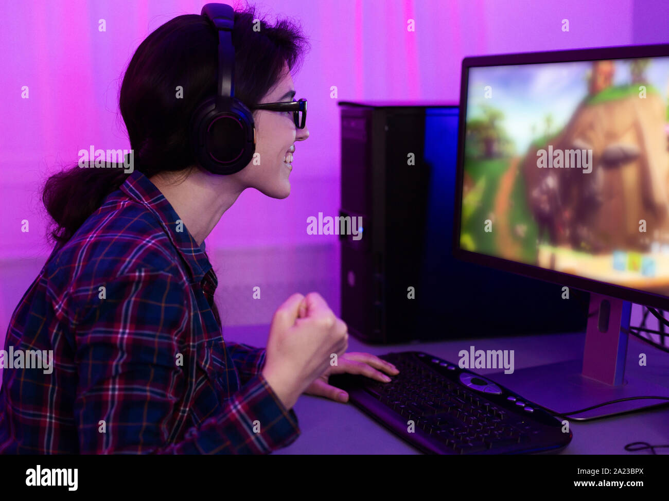 Excited gamer girl rejoicing, winning in video game, wearing glasses ...