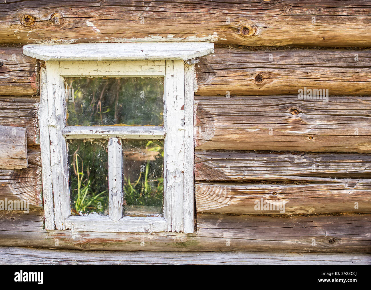 old wooden window with peeling white paint in an ancient a log cabin in ...