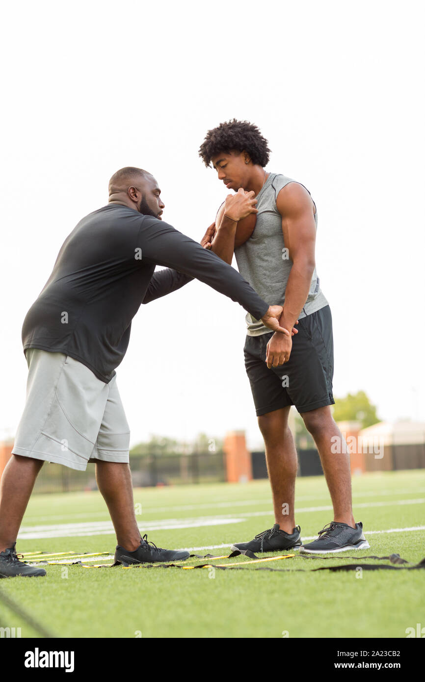 American Football coach training a young athlete Stock Photo - Alamy