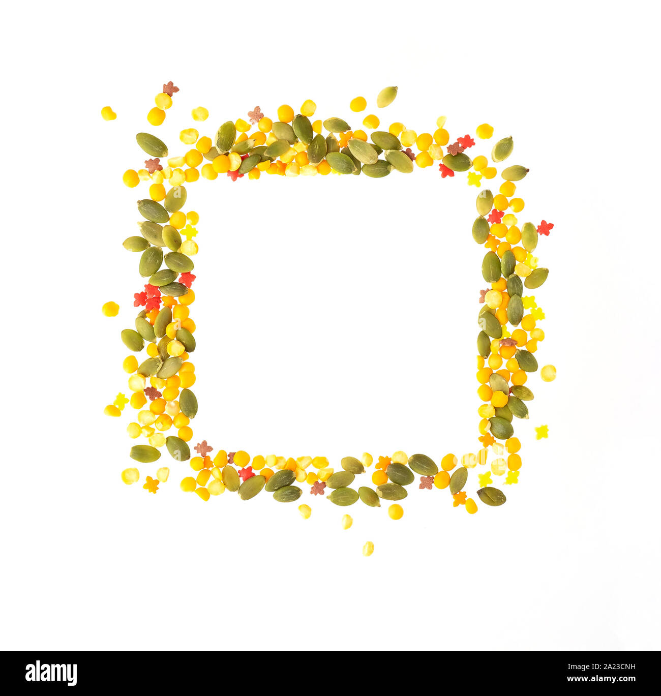 Square frame, border made of green pumpkin seeds, yellow peas and red ...