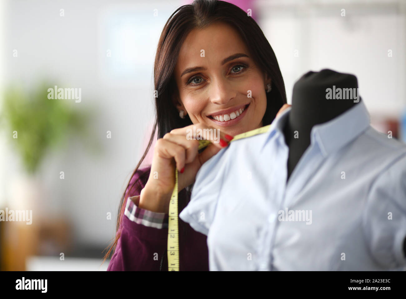 Joyful female tailor Stock Photo - Alamy