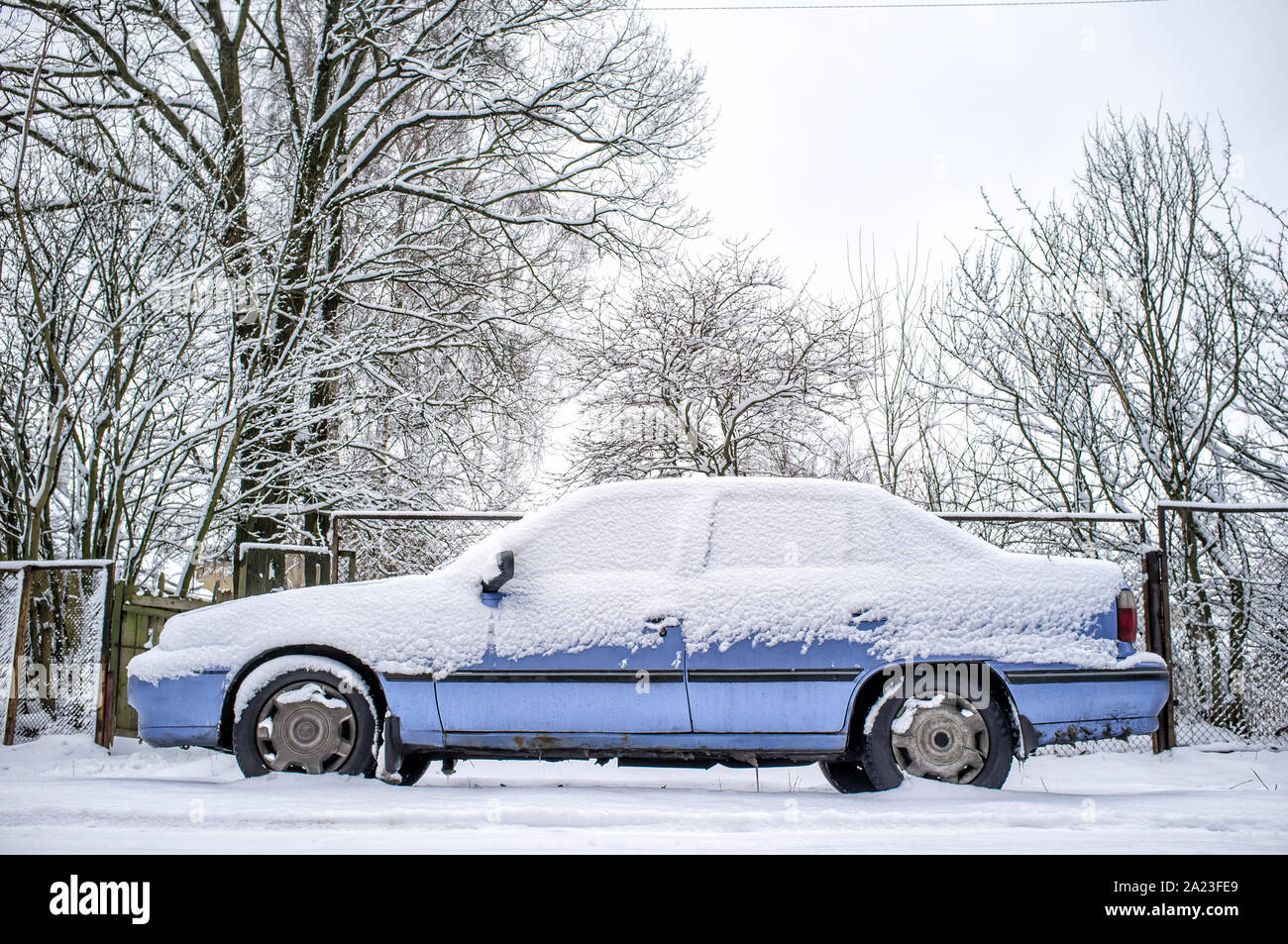 old rusty blue car covered with snow in winter Stock Photo - Alamy