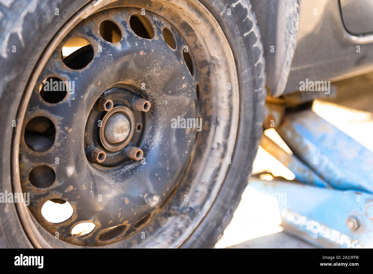 Wheel replacement. Work in tire shop. The rear wheel of the car before ...