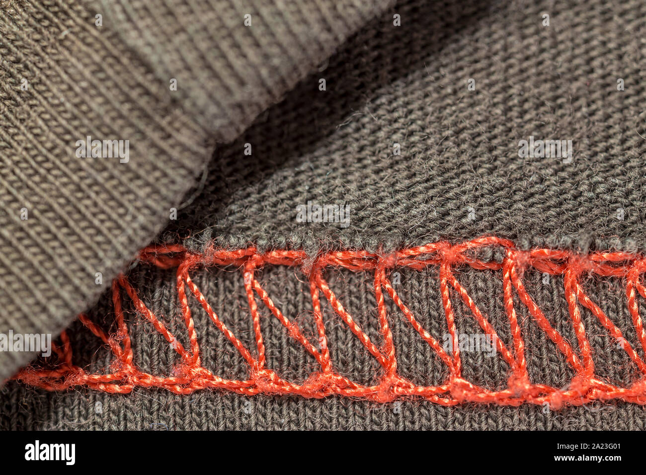 closeup macro red overlock seam on a brown T-shirt fabric Stock Photo ...