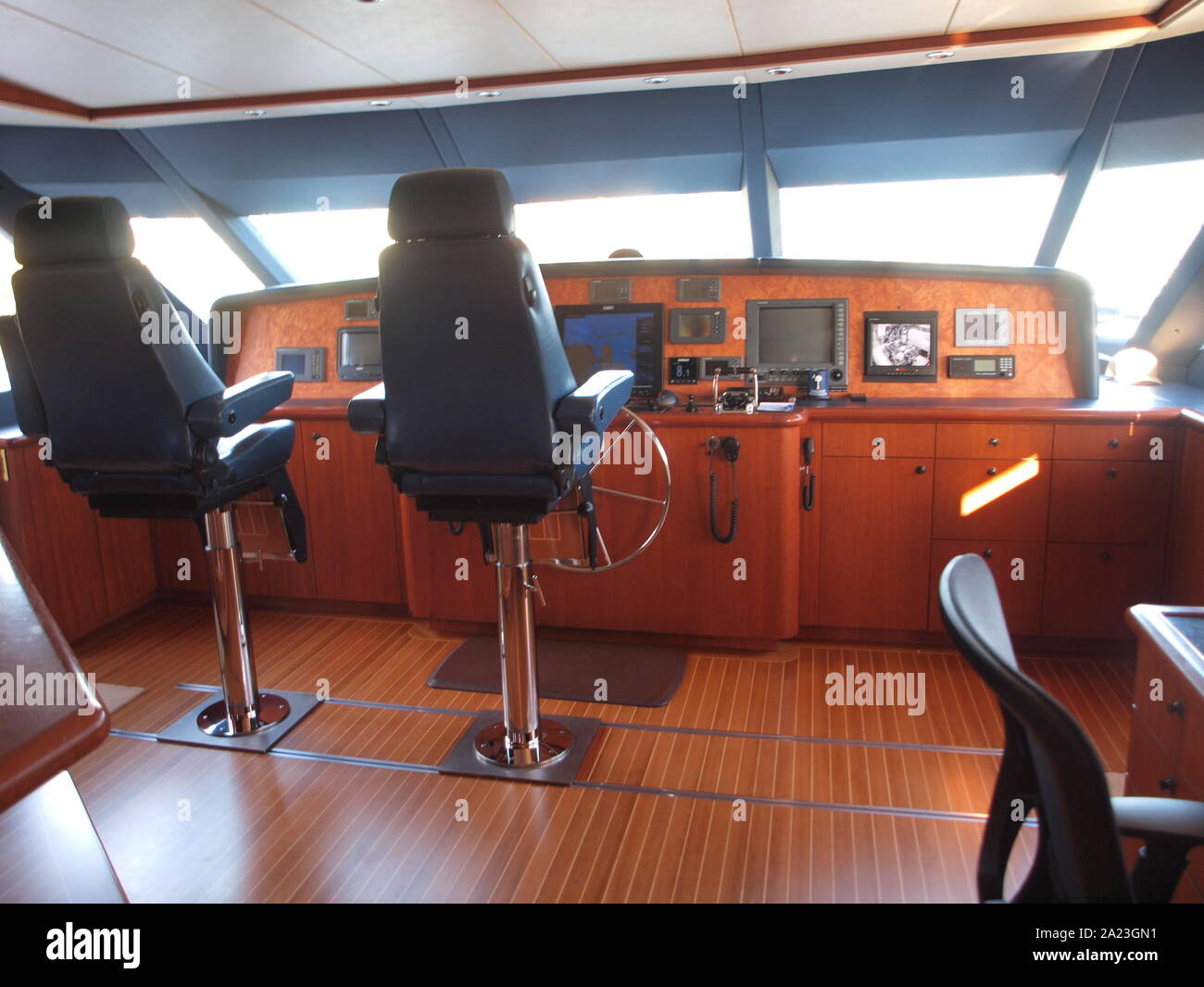 Bridge of expensive yacht with high tech controls and radar screens ...