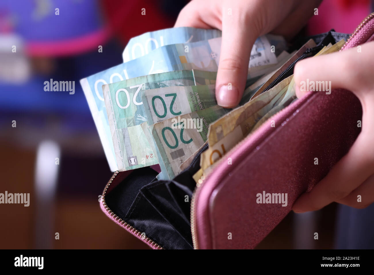 Counting money in a wallet Stock Photo - Alamy