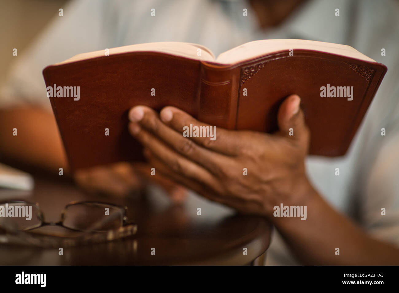 African American man praying and reading the Bible Stock Photo - Alamy