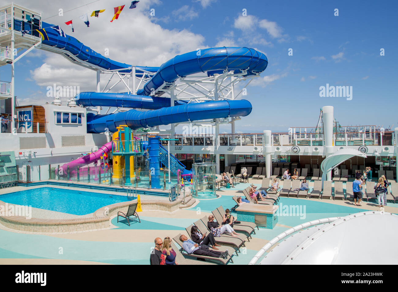 Swimming pools and waterslide on board the NCL Bliss Stock Photo - Alamy