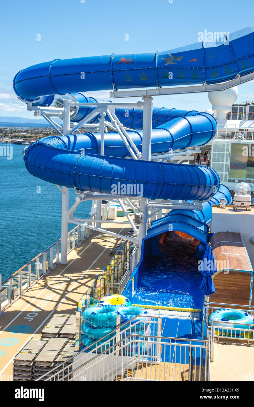 Swimming pools and waterslide on board the NCL Bliss Stock Photo - Alamy