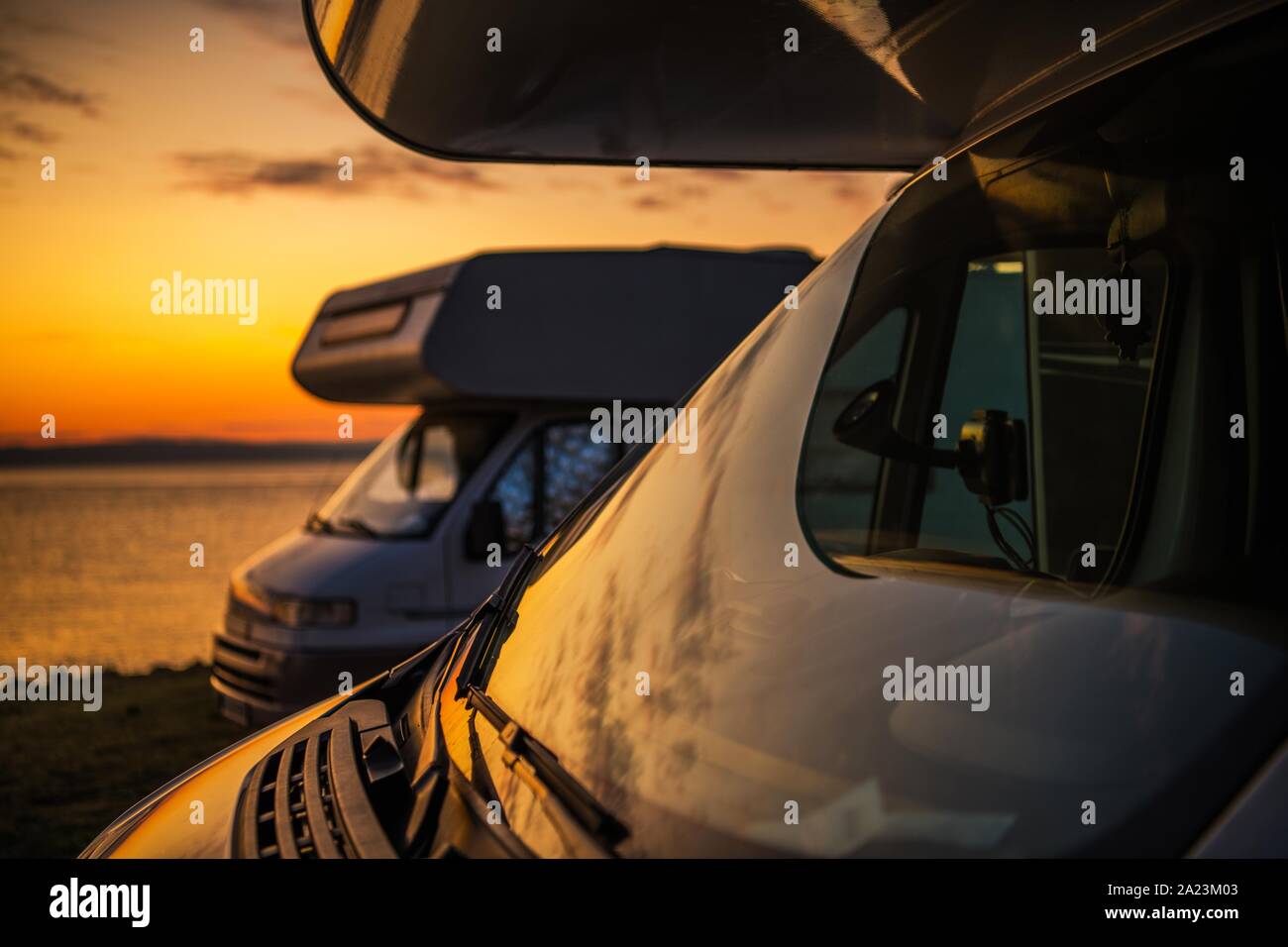 RV Camper Vans Camping. Two Motorhomes and the Scenic Sunset. Closeup ...
