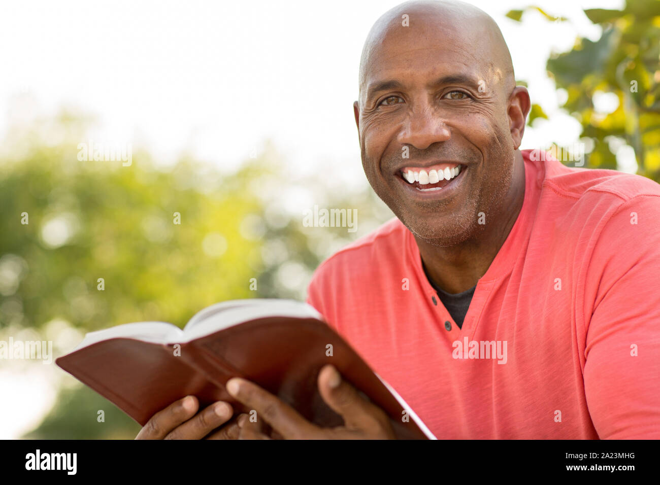 African American man praying and reading the Bible Stock Photo - Alamy