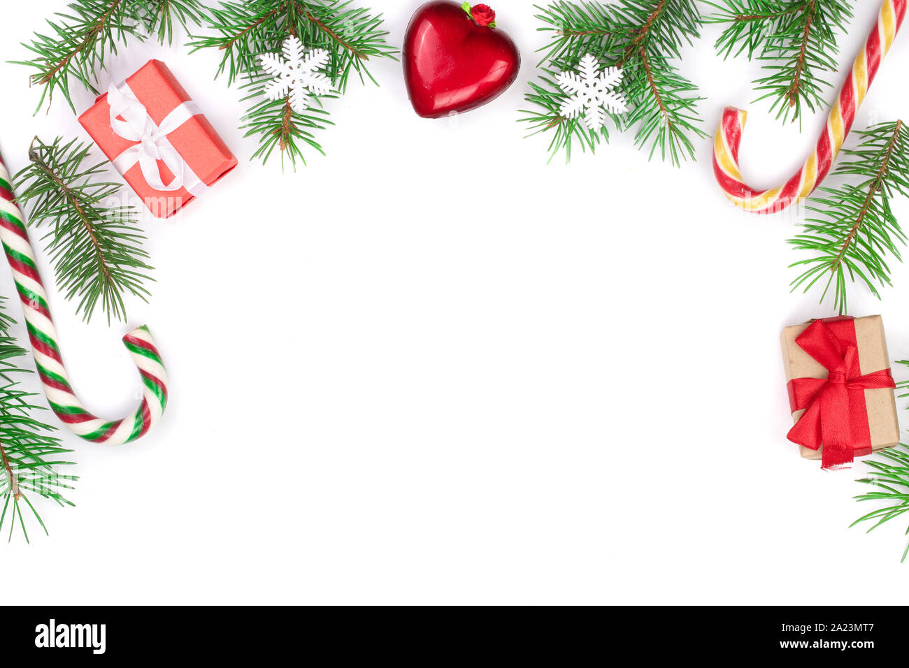 Christmas Frame of Fir tree branch with candy canes and snow isolated ...
