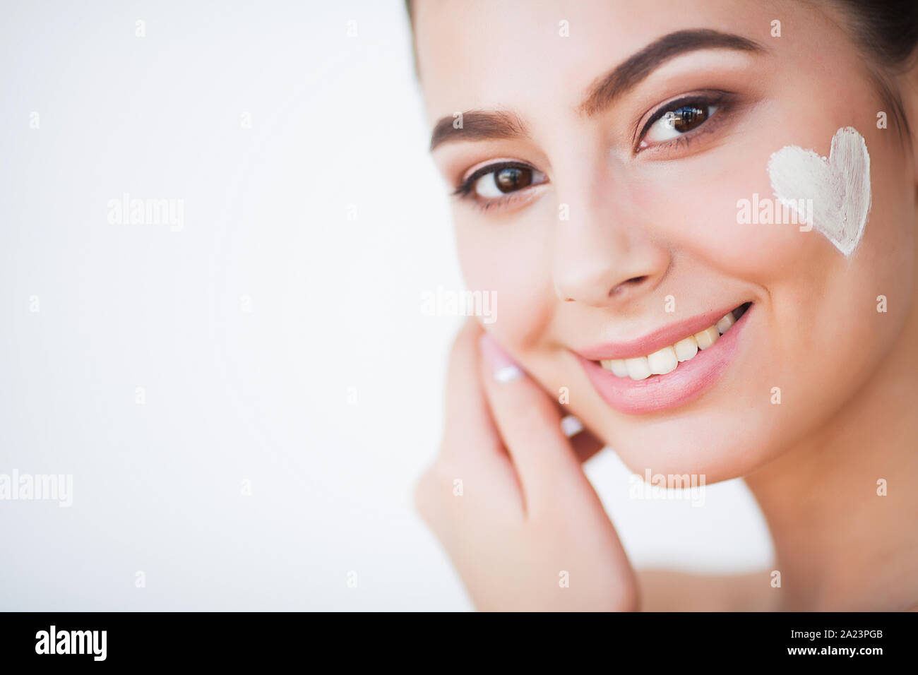 Beautiful woman using a skin care product, moisturizer or lotion and ...