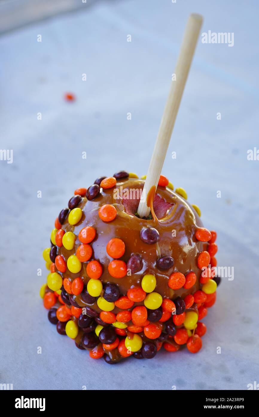 Caramel candied apple on a stick Stock Photo - Alamy