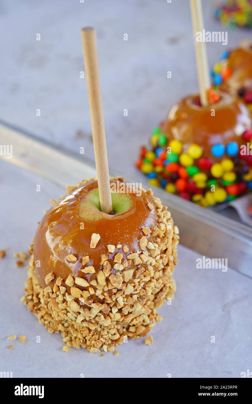 Caramel candied apple on a stick Stock Photo - Alamy