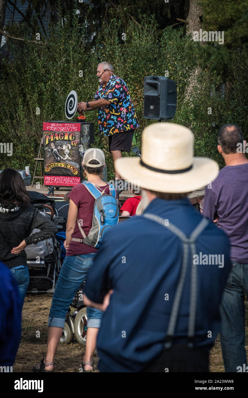 Amish family at country fair, auction Stock Photo - Alamy