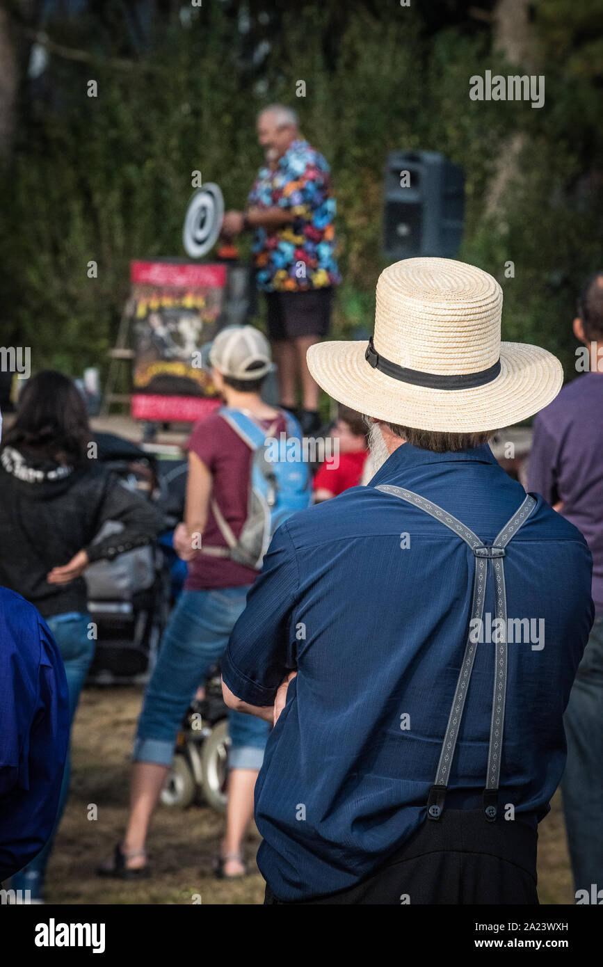 Amish family at country fair, auction Stock Photo - Alamy