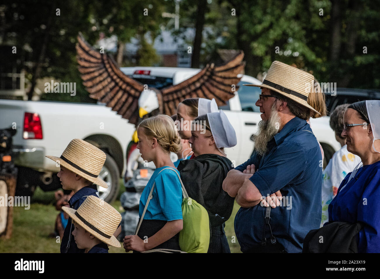 Amish family at country fair, auction Stock Photo - Alamy