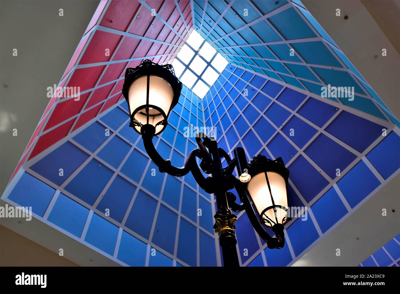 Abstract perspective of vertical lobby ceiling with skylight and strong ...