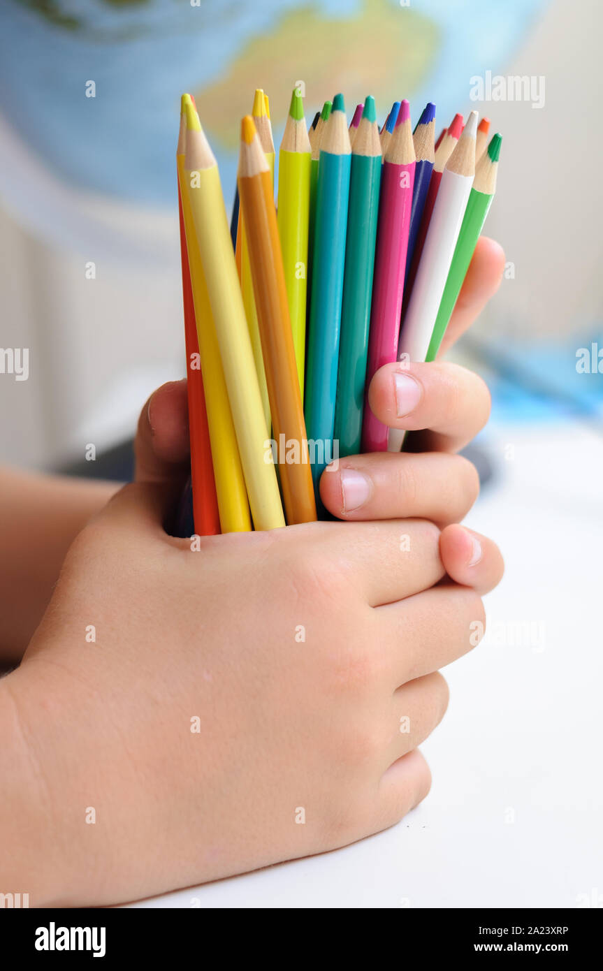 wooden colored pencils for drawing in hand Stock Photo - Alamy