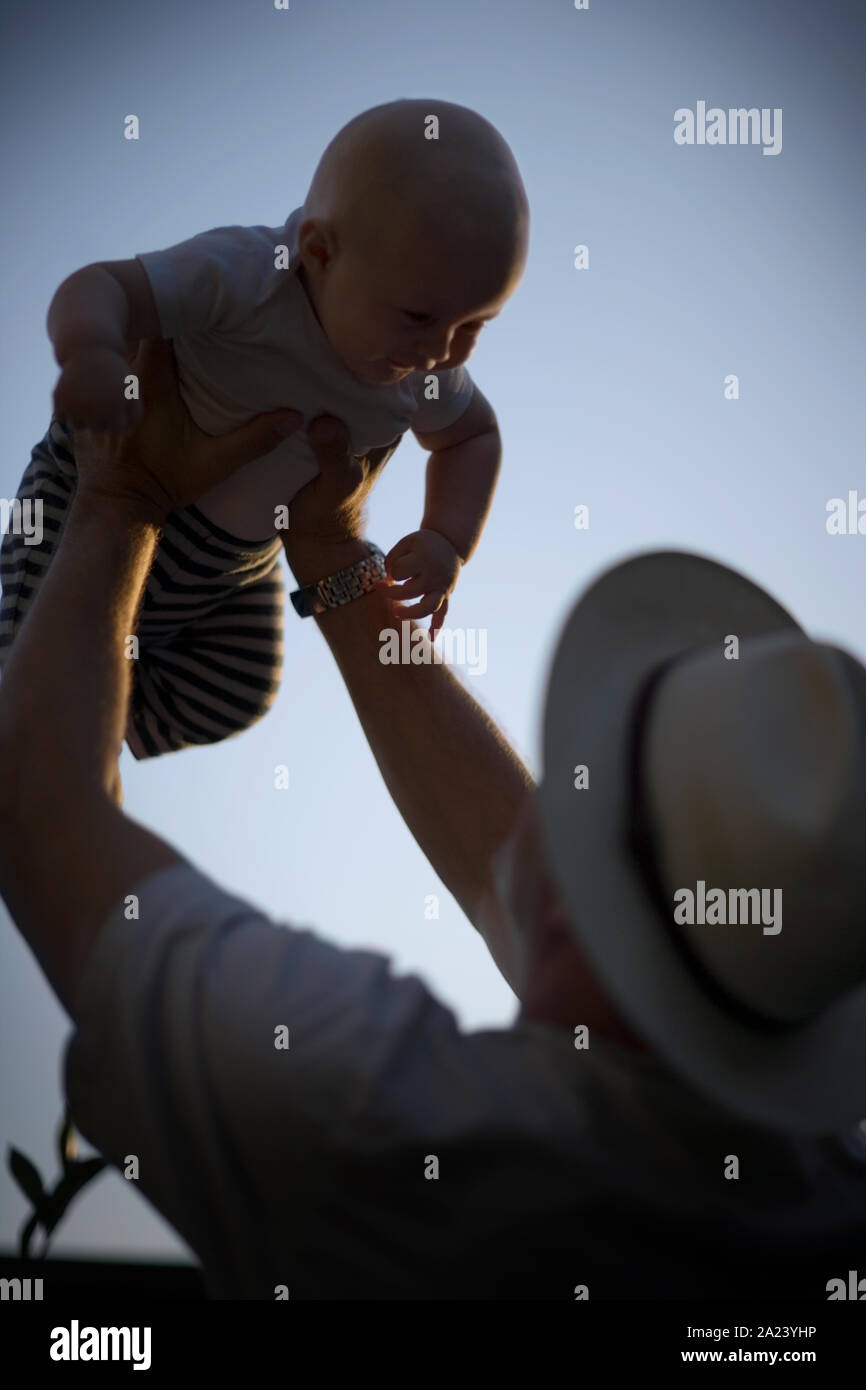 Young baby being held aloft by his father Stock Photo - Alamy