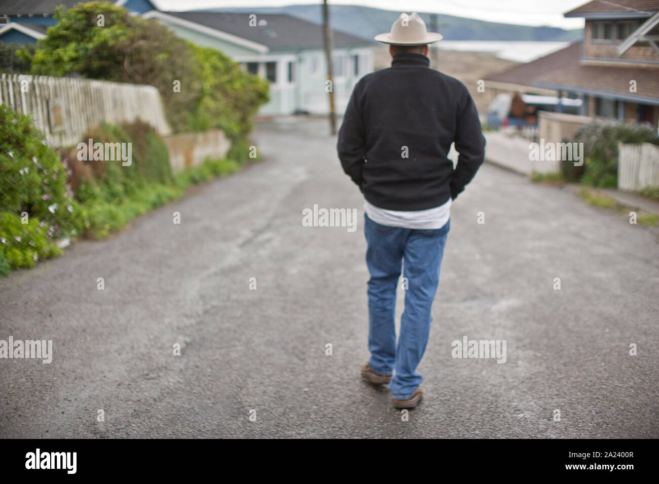 Man walking down street house hi-res stock photography and images - Alamy