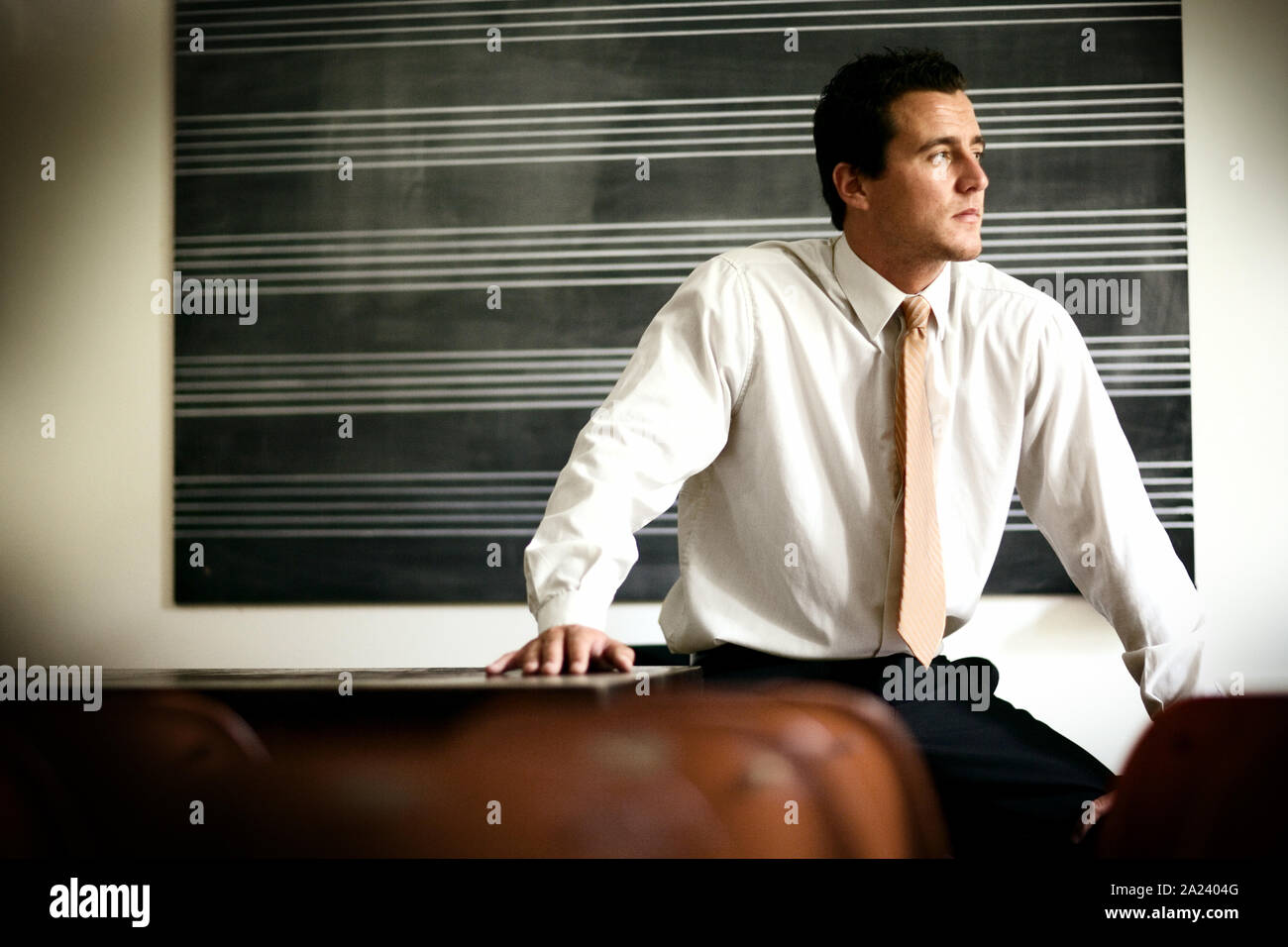 Portrait of a young man in formal attire at his office Stock Photo - Alamy