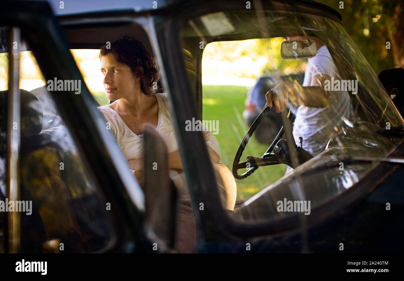 Side view of a woman sitting inside a car Stock Photo - Alamy