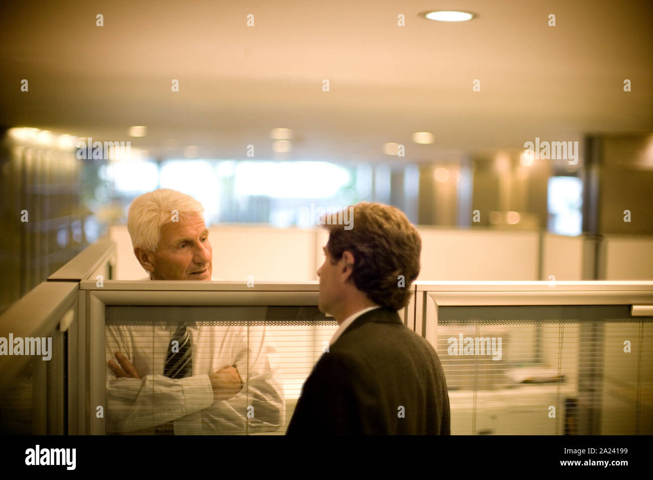 Side view of two men engaged in a conversation Stock Photo - Alamy