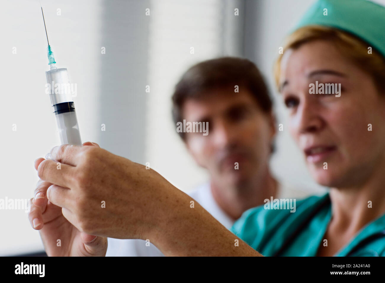 Side view of a doctor with a syringe in her hand Stock Photo - Alamy