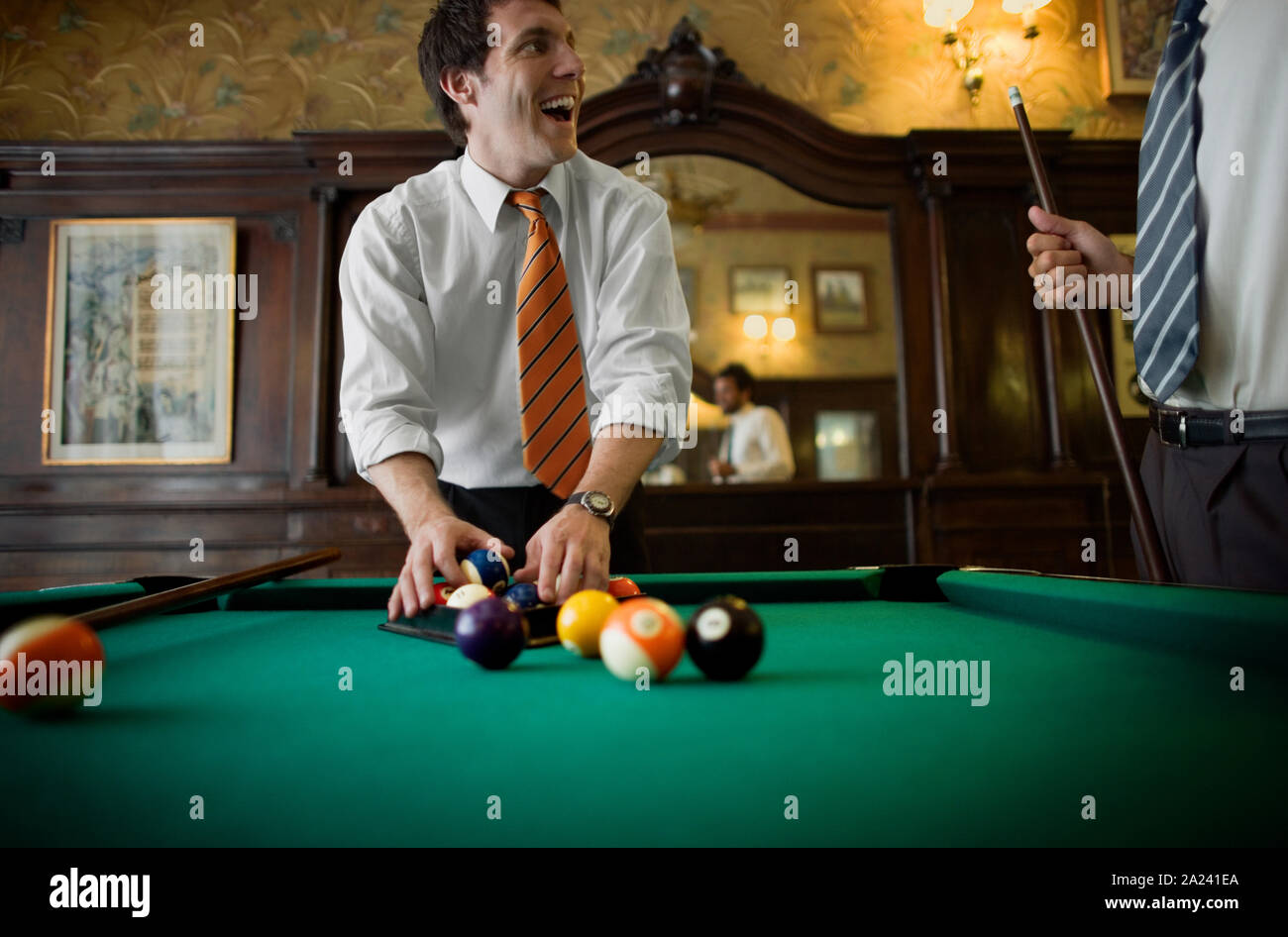 View of a man arranging pool balls on a pool table Stock Photo - Alamy