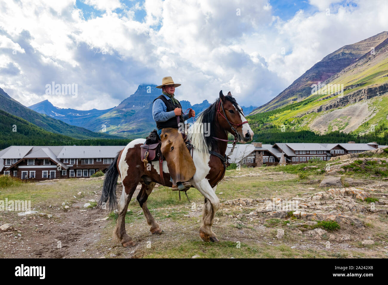 Montana, AUG 25: Cowboy riding on a horse in the Many Glacier area of ...