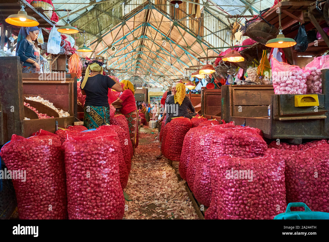 Women busy sorting and selling red onions in the vegetable section at ...
