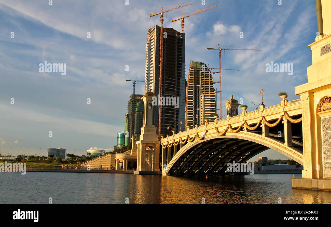 Putrajaya bridge one evening with building under construction in ...