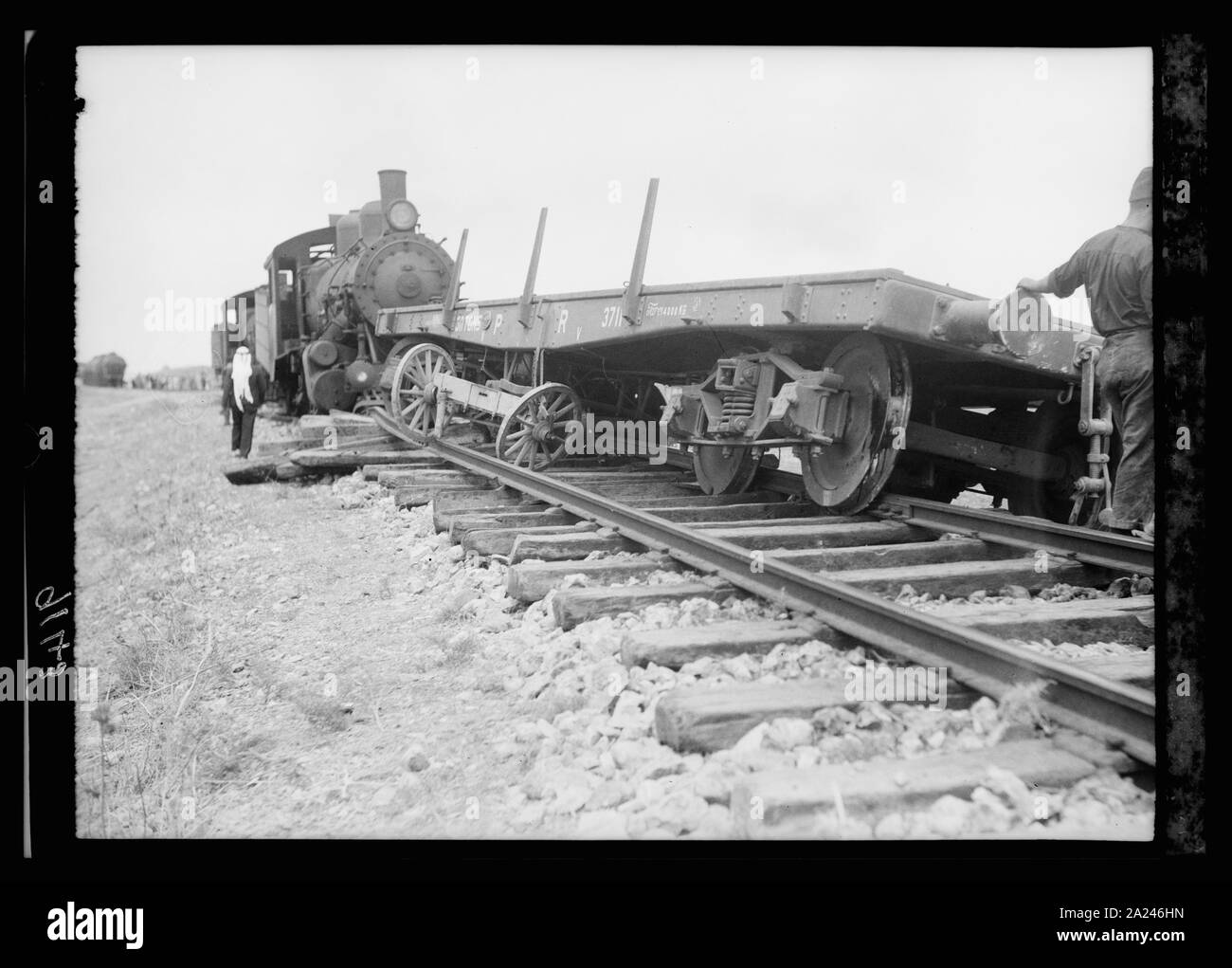 Palestine disturbances 1936. Derailed engine and flat car near Ras el ...