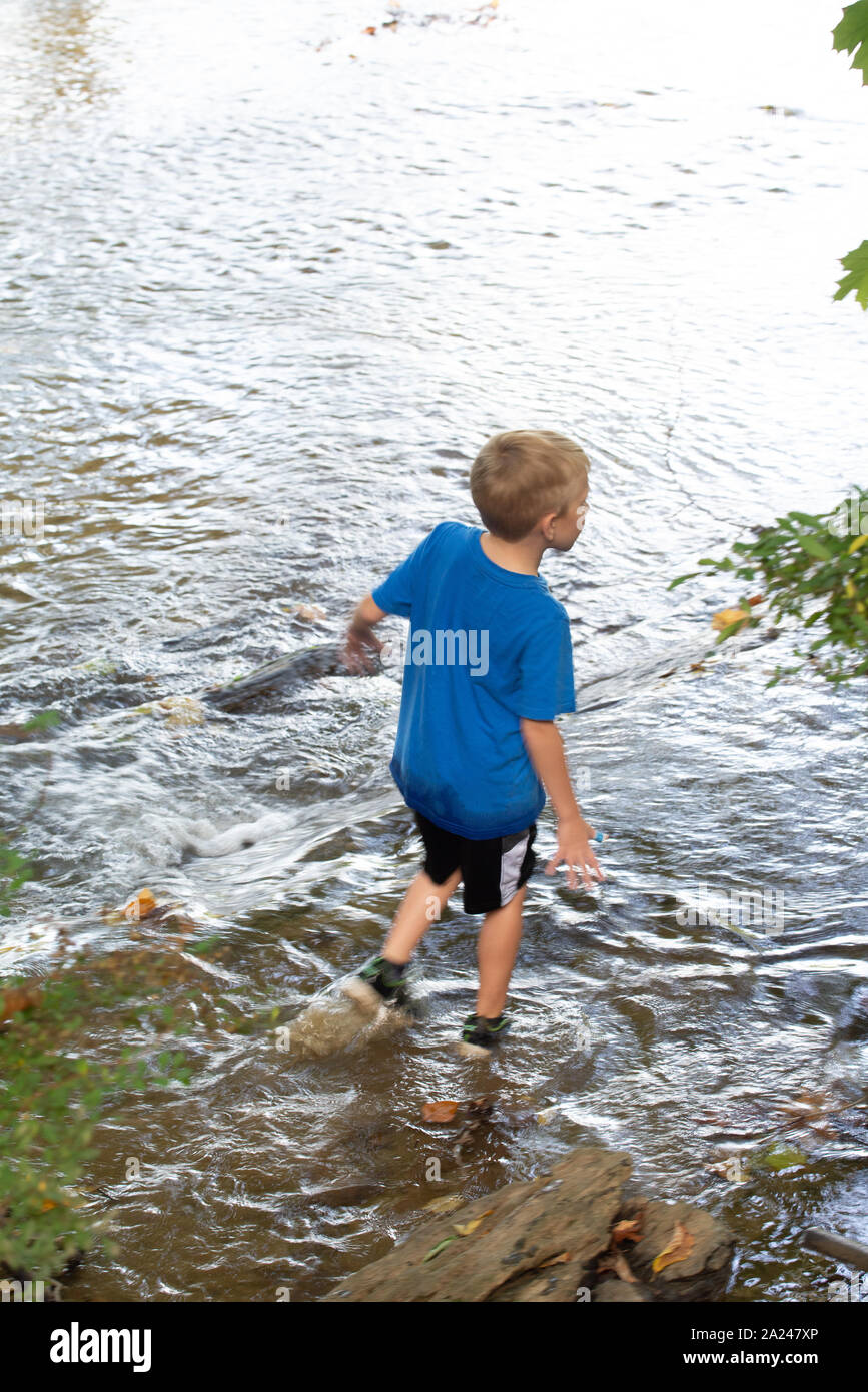 Young boys enjoy exploring in creek Stock Photo - Alamy