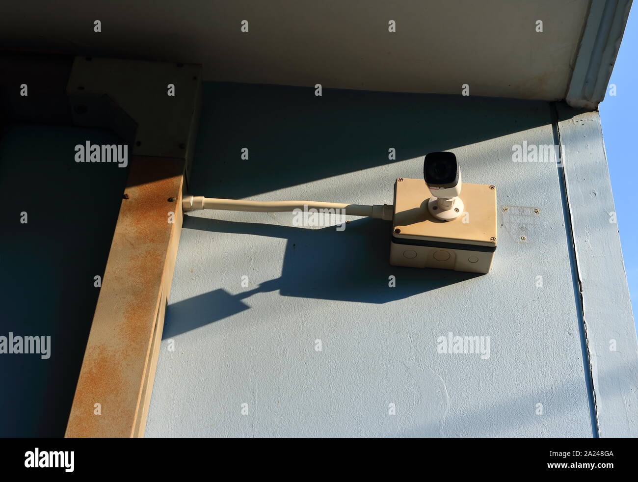 Security camera installed on the wall of a building under sunlight and ...