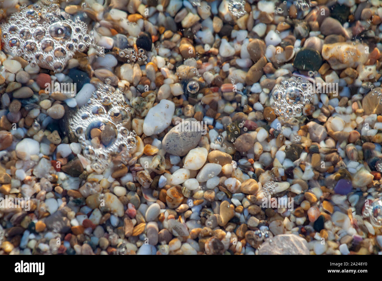 sea pebbles colored granite on the beach background stones. The shore ...