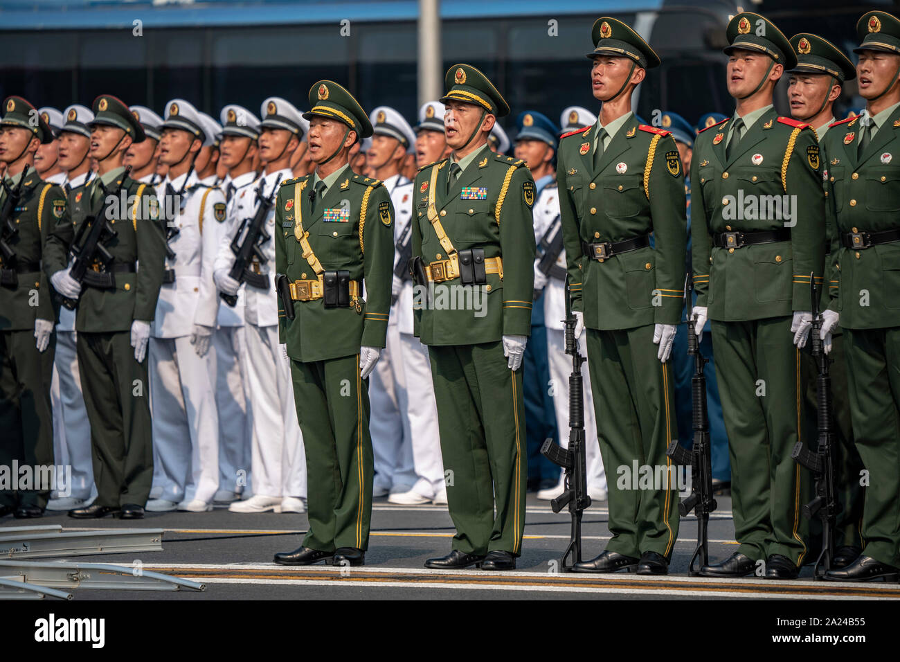 Beijing, China. 1st Oct, 2019. Troops sing China's national anthem ...