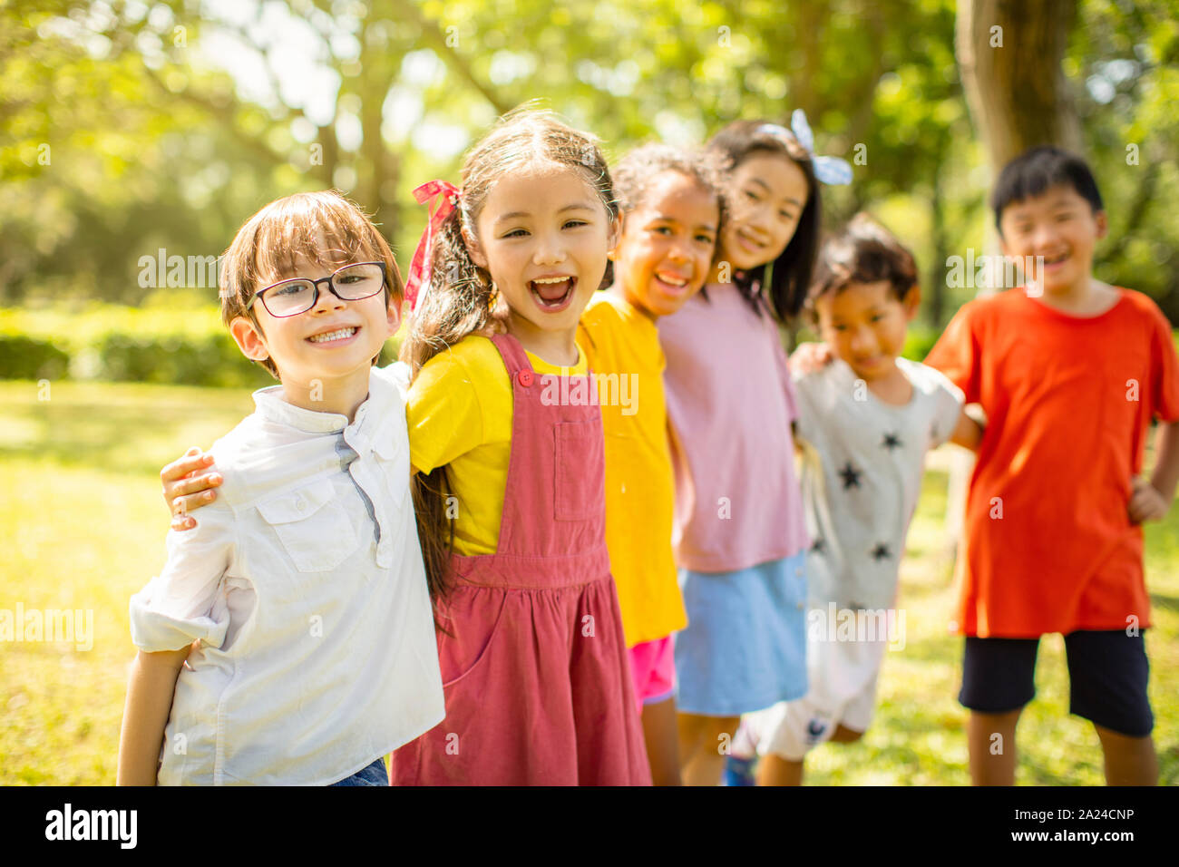 Multi-ethnic group of school children laughing and embracing Stock ...